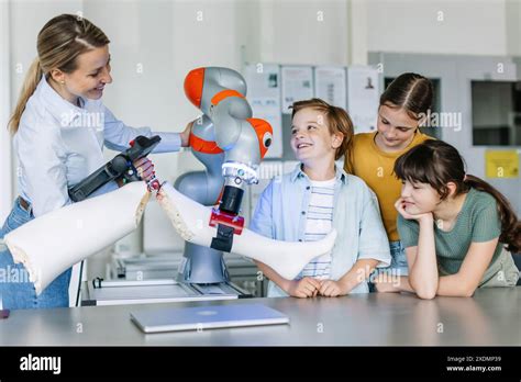 Children learning robotics in Elementary school. Young students going on field trip to real ...