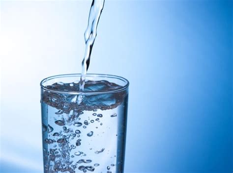 Premium Photo Close Up Of Drinking Glass In Water Against Blue Background