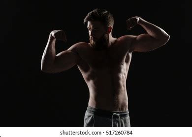 Naked Athletic Man Demonstrates Biceps Isolated Stock Photo 517260784