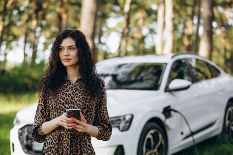 Premium Photo Woman Charging Electro Car At The Electric Gas Station