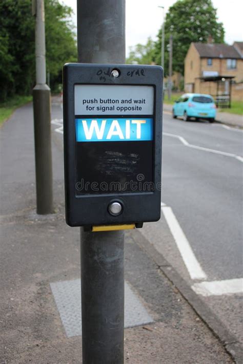 Pedestrian Crossing Control Panel That Says Push Button And Wait For Signal Opposite Wait Stock