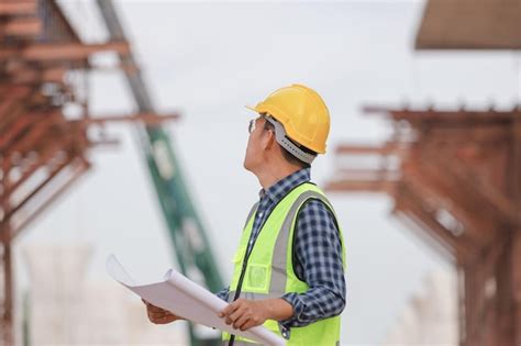 Premium Photo Engineer Man With Blueprint At Construction Site Foreman Worker Holding Plan In