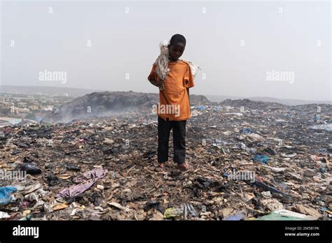 Small African Garbage Collector Scavenging The Ground For Reusable