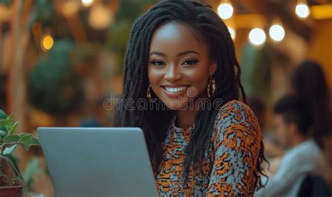 Happy Young Black Woman With Dreadlocks Working Remotely On Her Laptop