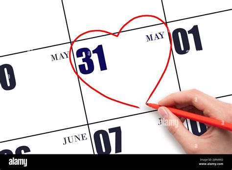 St Day Of May A Woman S Hand Drawing A Red Heart Shape On The Calendar Date Of May Heart