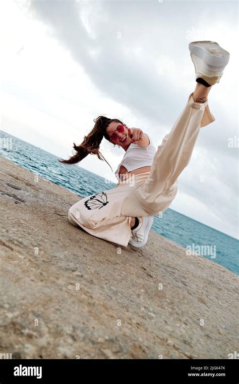 Female Hip Hop Dancer Smiling While Making A Freestyle Dance Pose