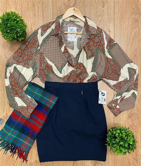 The Shirt And Skirt Are On Display Next To Each Other Including A Plaid Scarf