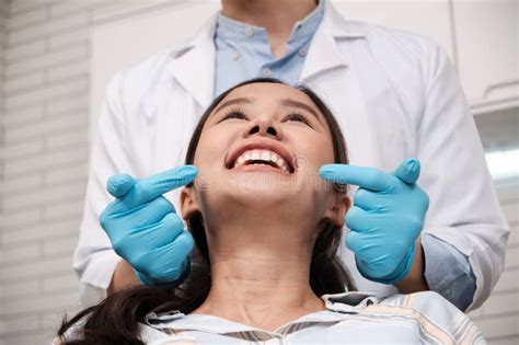 Asian Female Face White Teeth And Cheerful Face In The Dentist Clinic