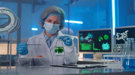 A Female Scientist Observes The Dissolution And Spread Of A Green