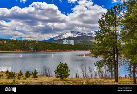 Pikes Peak Panorama Snow Capped And Forested Mountains Near A Mountain
