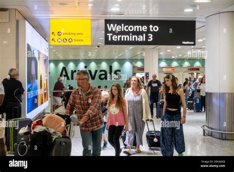 Passengers Arriving At London Heathrow Airport Terminal 3 Passing Out
