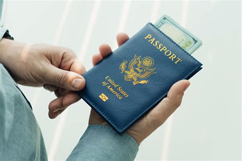 American Passport And Dollars In Businessmans Hands Citizen Of The