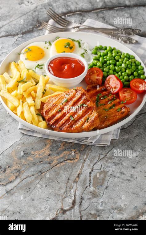Délicieux steak de longe grillé avec petits pois œufs frits frites