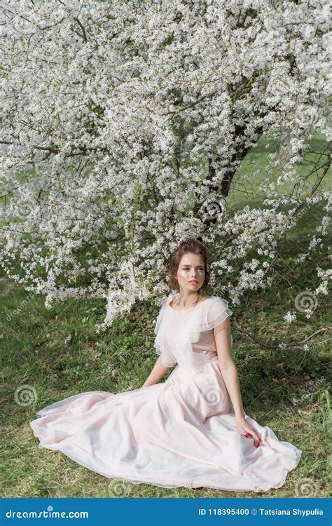 Beautiful Tender Sweet Girl In A Pink Dress With A Hairdo Near