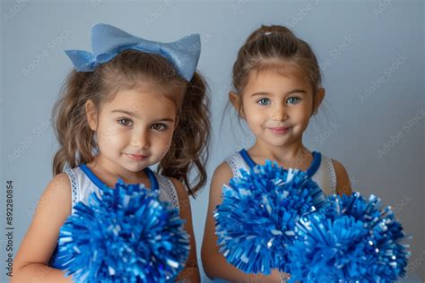Two Smiling Girls In Blue Cheerleading Outfits With Pompoms Cute Happy