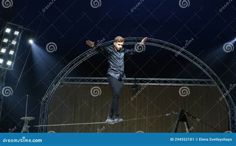 A Tightrope Walker Or Balancer Performs Tricks On A Tightrope In A
