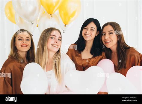 Beautiful Girlfriends Celebrating Birthday Wearing Satin Robeswomen