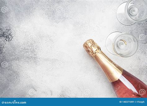 Bottle With Pink Sparkling Wine Or Rose Champagne And Glasses Gray