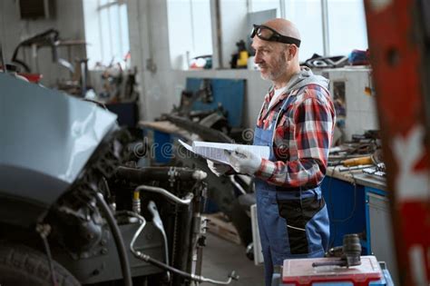 Employee Of A Car Repair Shop Stands In The Workshop Stock Image