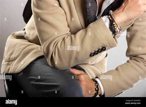 Close Up Of Man Wearing Smart Casual Clothes Posing Sitting On Chair On