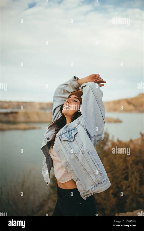 Side View Of Happy Youthful Charming Female Tourist Looking Away While