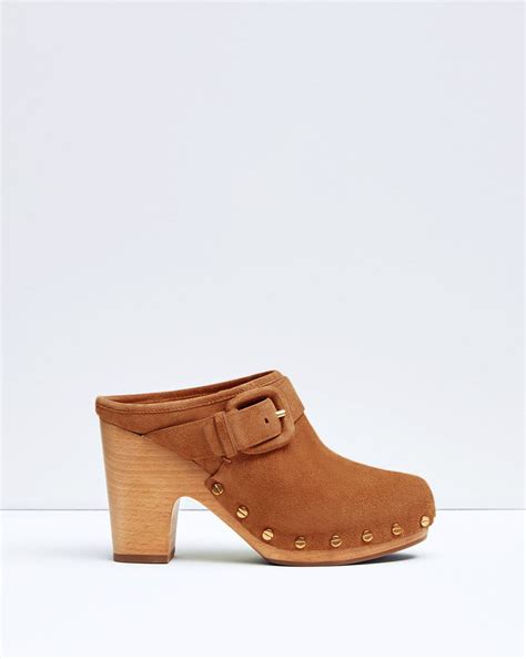 A Buckled Accent Studded Trim And Stacked Heel Define The Effortlessly