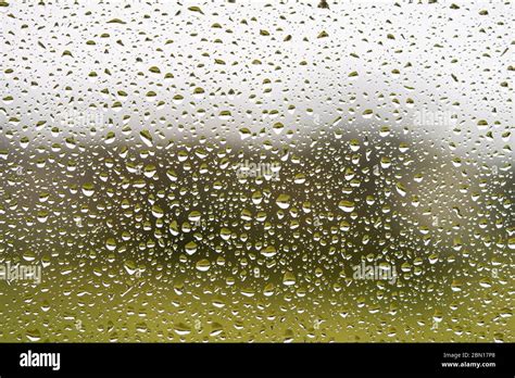 Rain Drops On Glass Window Dark Grey And Green Textured Background