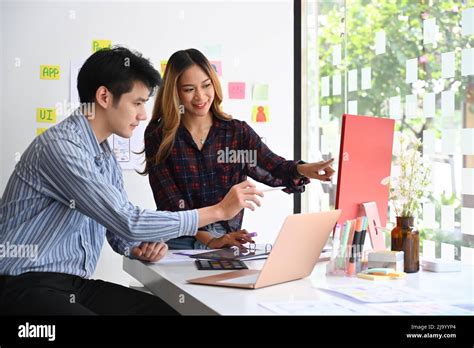 Young Creative People Brainstorming About Mobile App Interface Wireframe Design Together Stock