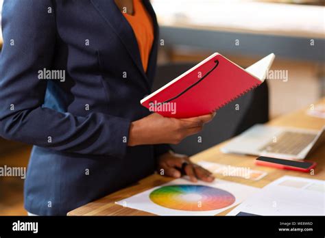 Interior Designer Reading Notes In Her Pink Notebook Stock Photo Alamy