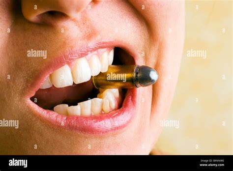 Biting The Bullet Stock Photo Alamy