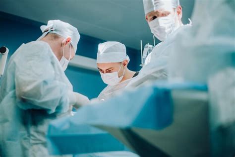 Premium Photo A Team Of Surgeons Performs A Complex Operation To