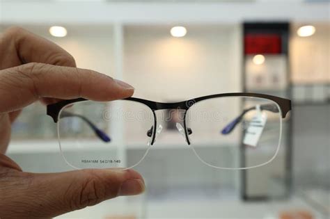 Hand Holding Glasses In Eyeglasses Shop Glasses In Female Hand Stock