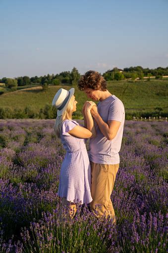 Couple In Purple Matching Lilac Outfit Hugging Kissing In Lavender
