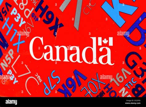The Word Canada In The Center Of Diverse Postal Codes In A Canadian