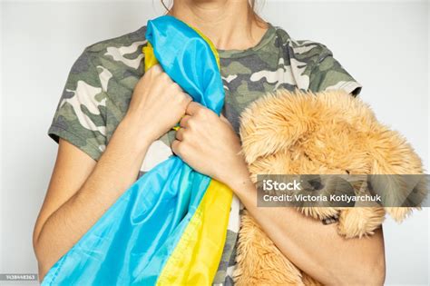봉제 토끼와 흰색 배경에 손에 우크라이나 국기를 든 군복을 입은 여성 집으로 돌아가다 군인 여성 전쟁 2022 군사에 대한 스톡