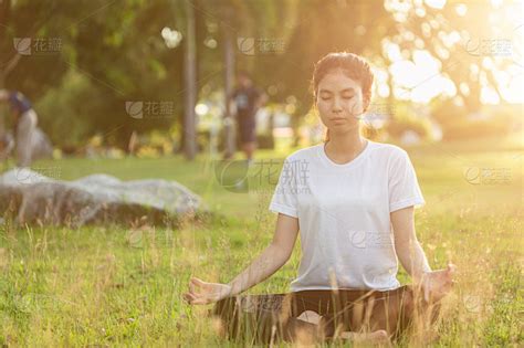漂亮的亚洲女人在公园里做瑜伽