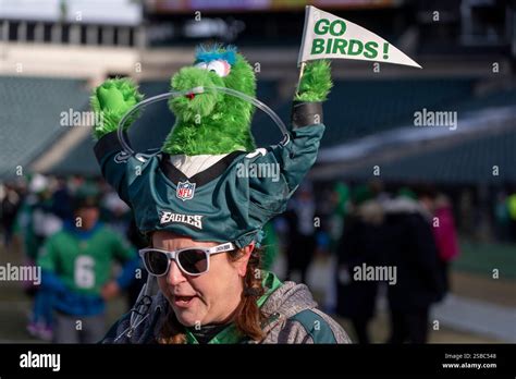 A Philadelphia Eagles Fan Wearing A Phillie Phanatic Hat Dressed In