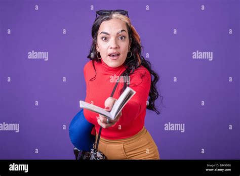 Woman Holding Passport And Suitcase While Running Against Purple