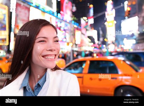 Woman In New York City Manhattan Times Square At Night Smiling Happy