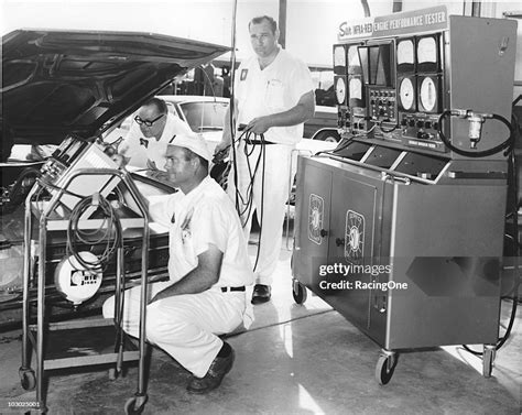 Crew Members Use An Engine Scope To Fine Tune An Engine In A Nascar