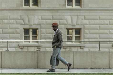 African American Business Man Walking In A Suit With His Bag By