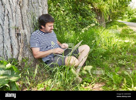 Business Man As Programmer On Laptop Pc In Garden On Summer Vacation