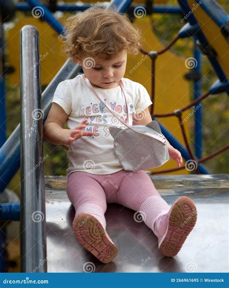 A Beautiful Girl Sitting On A Slide And Looking Around Halle An Der Saale Saxony Anhalt Stock