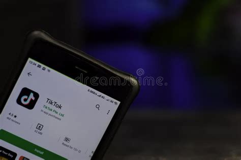 tiktok dev app with magnifying on smartphone screen editorial stock