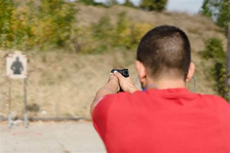 Back View Of Man Firing The Gun Creative Commons Bilder