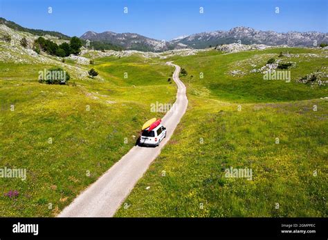 Aerial View Of A Car With Tourists Exploring Beautiful Lukavica Meadow