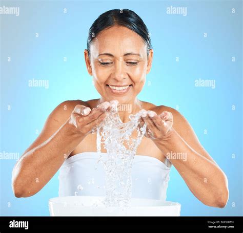 Water Splash Skincare And With A Woman Washing Her Face For Beauty