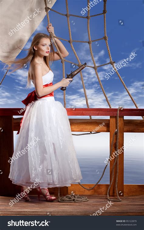 Beautiful Girl In White Dress On Deck Of The Sailing Ship With Pistol