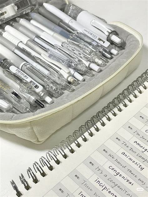 A Case Filled With Lots Of Different Types Of Pens And Pencils On Top Of A Table