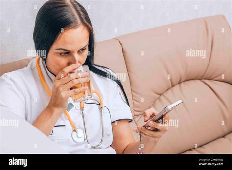 Work Life Balance Healthcare Worker Refreshes Herself With A Drink